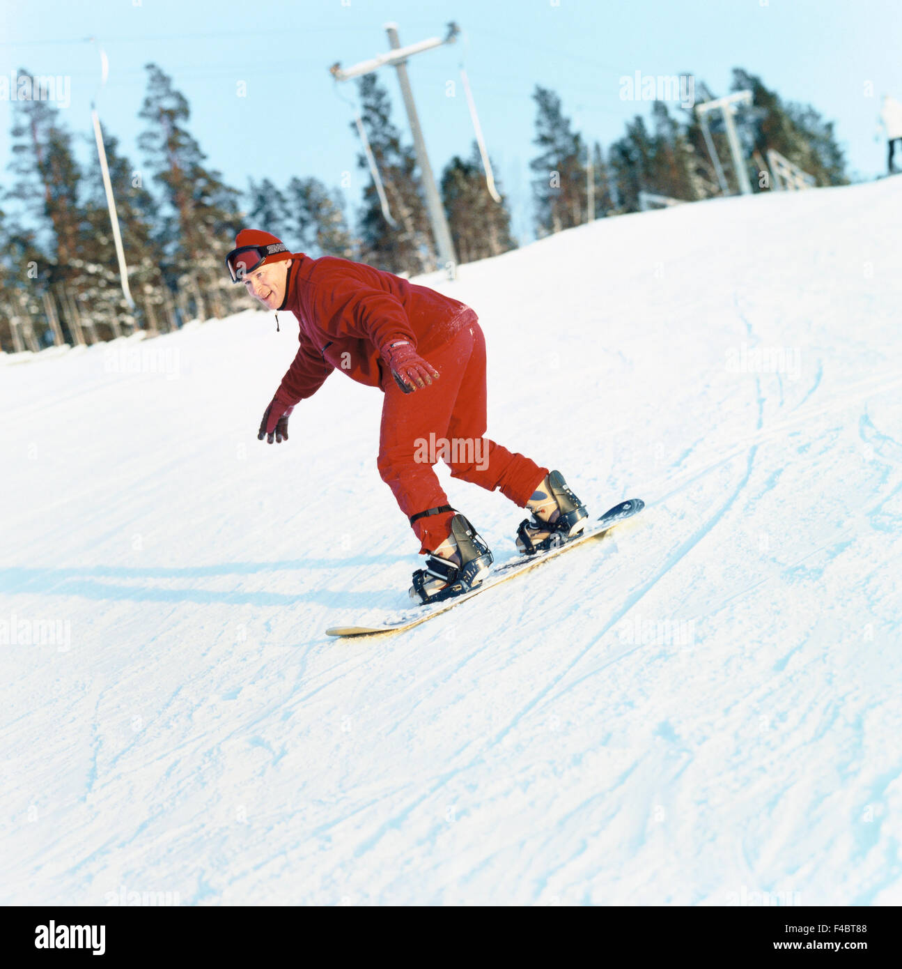Man snowboarding downhill Stock Photo - Alamy