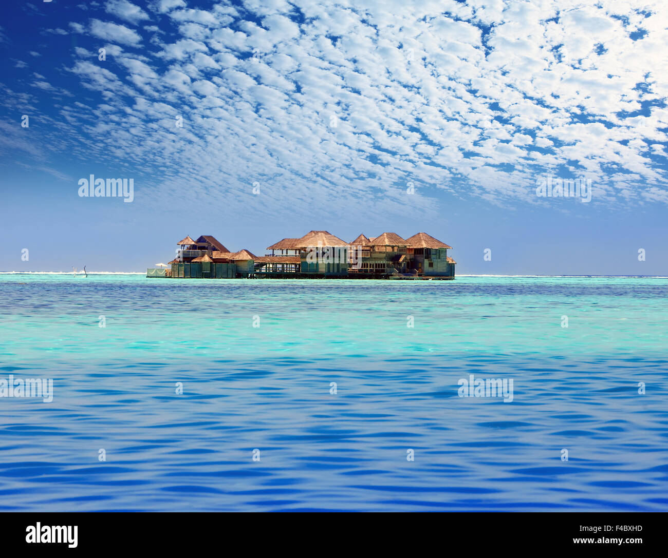 Island in ocean, overwater villas Stock Photo - Alamy