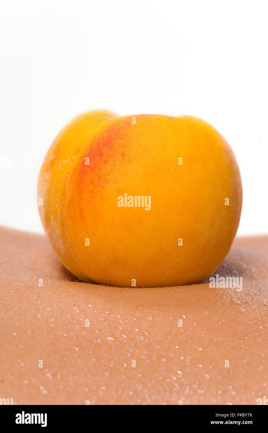peach lies at the female body Stock Photo - Alamy
