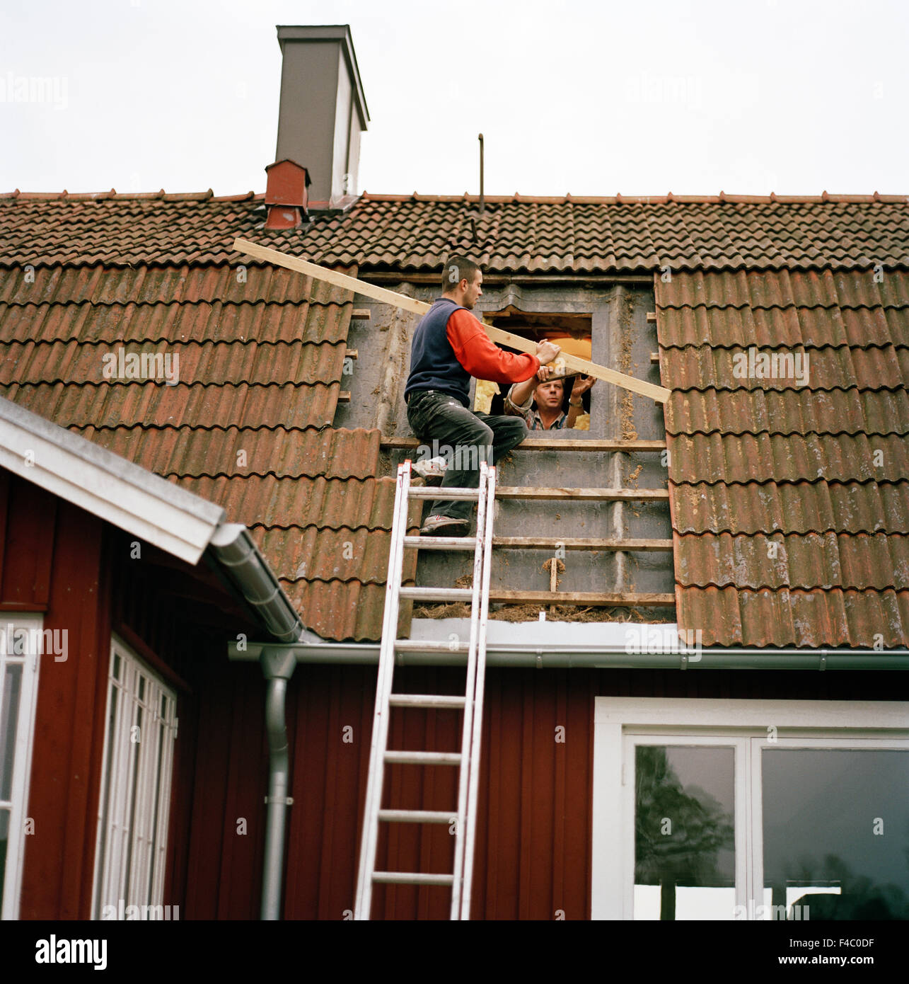 Two men rebuilding a house Stock Photo - Alamy