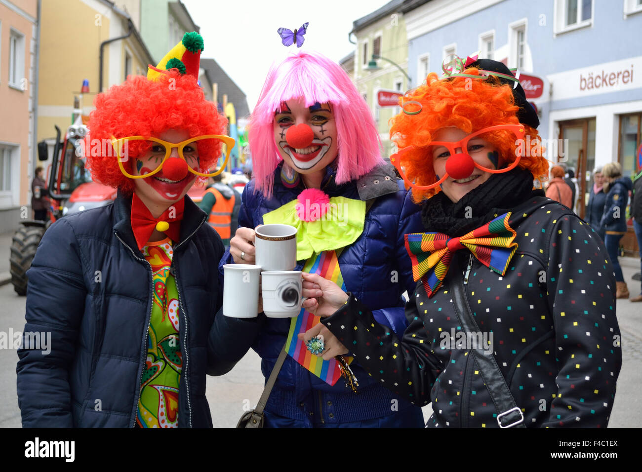 public carnival parade - Three Masked Stock Photo - Alamy