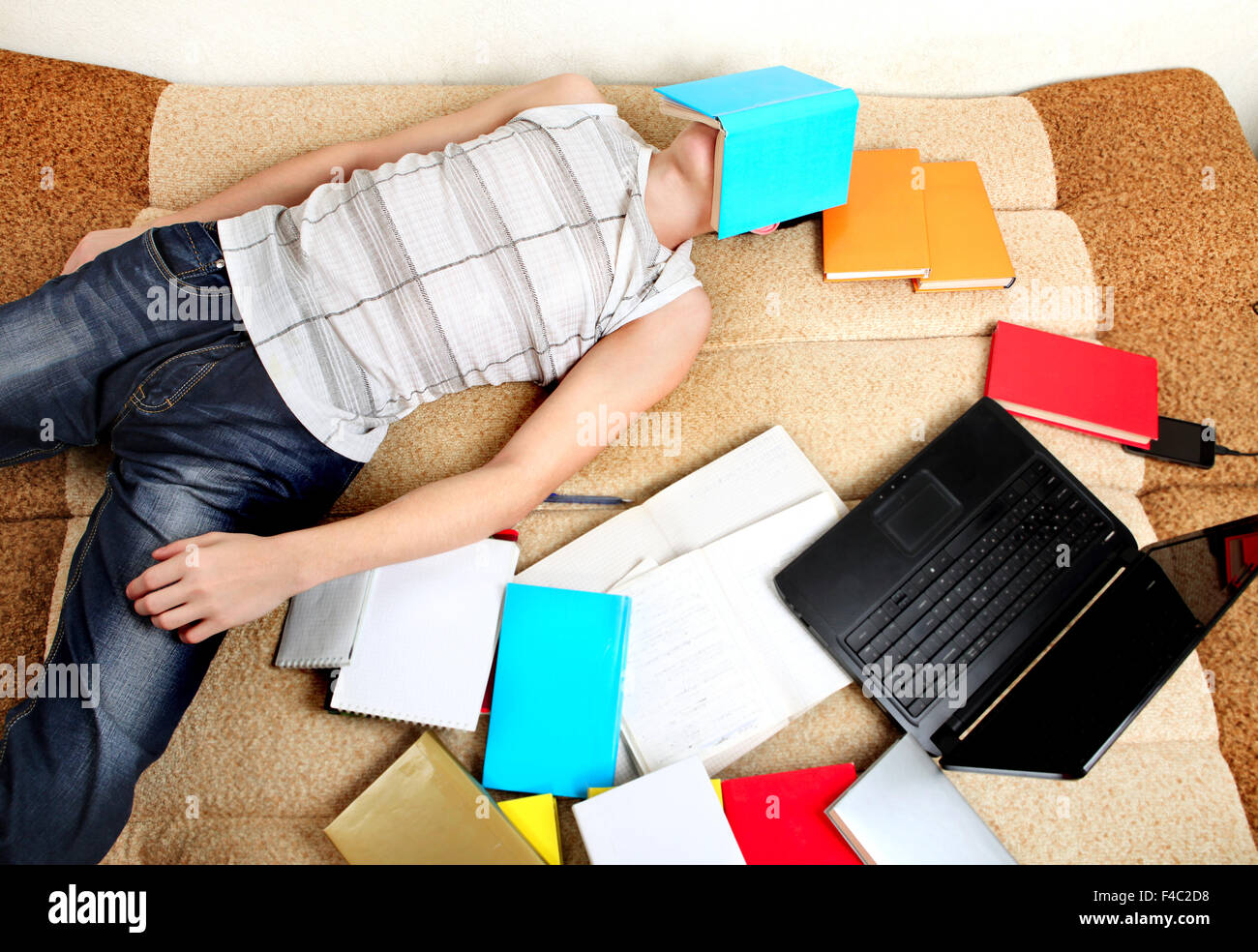Hard Tired Student on Sofa Stock Photo - Alamy