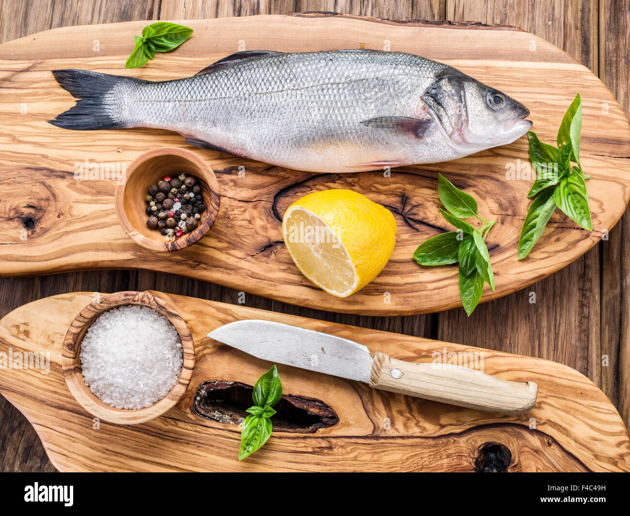Sea bass fish on the graphite board Stock Photo - Alamy