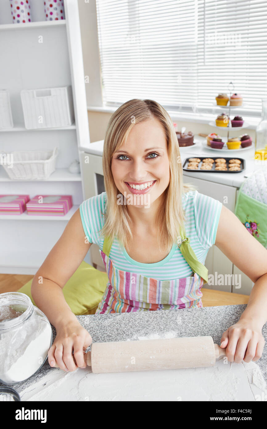 Cheerful woman baking in the kitchen Stock Photo - Alamy