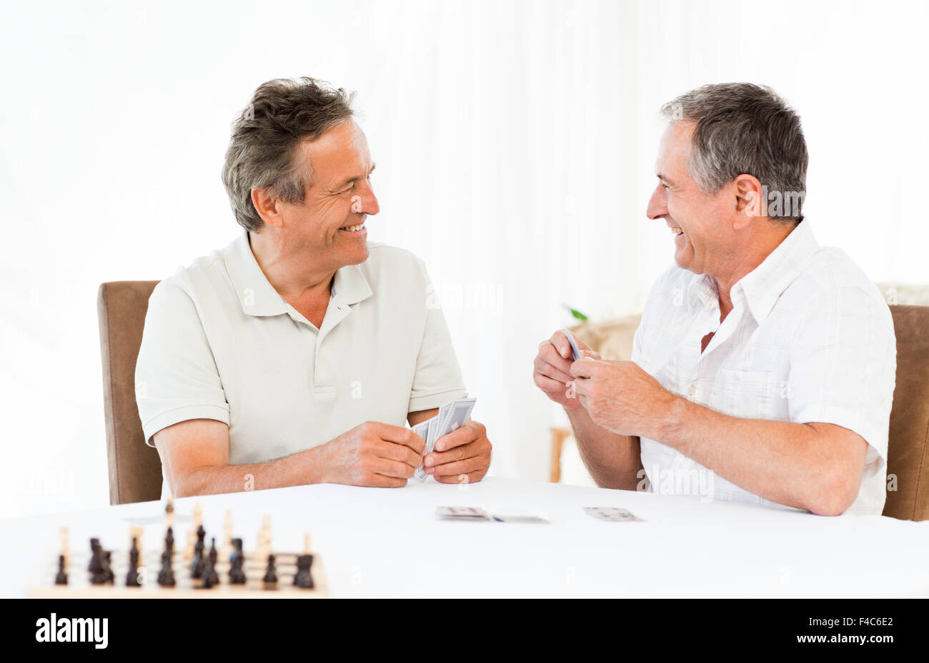 Men playing cards on the table Stock Photo - Alamy