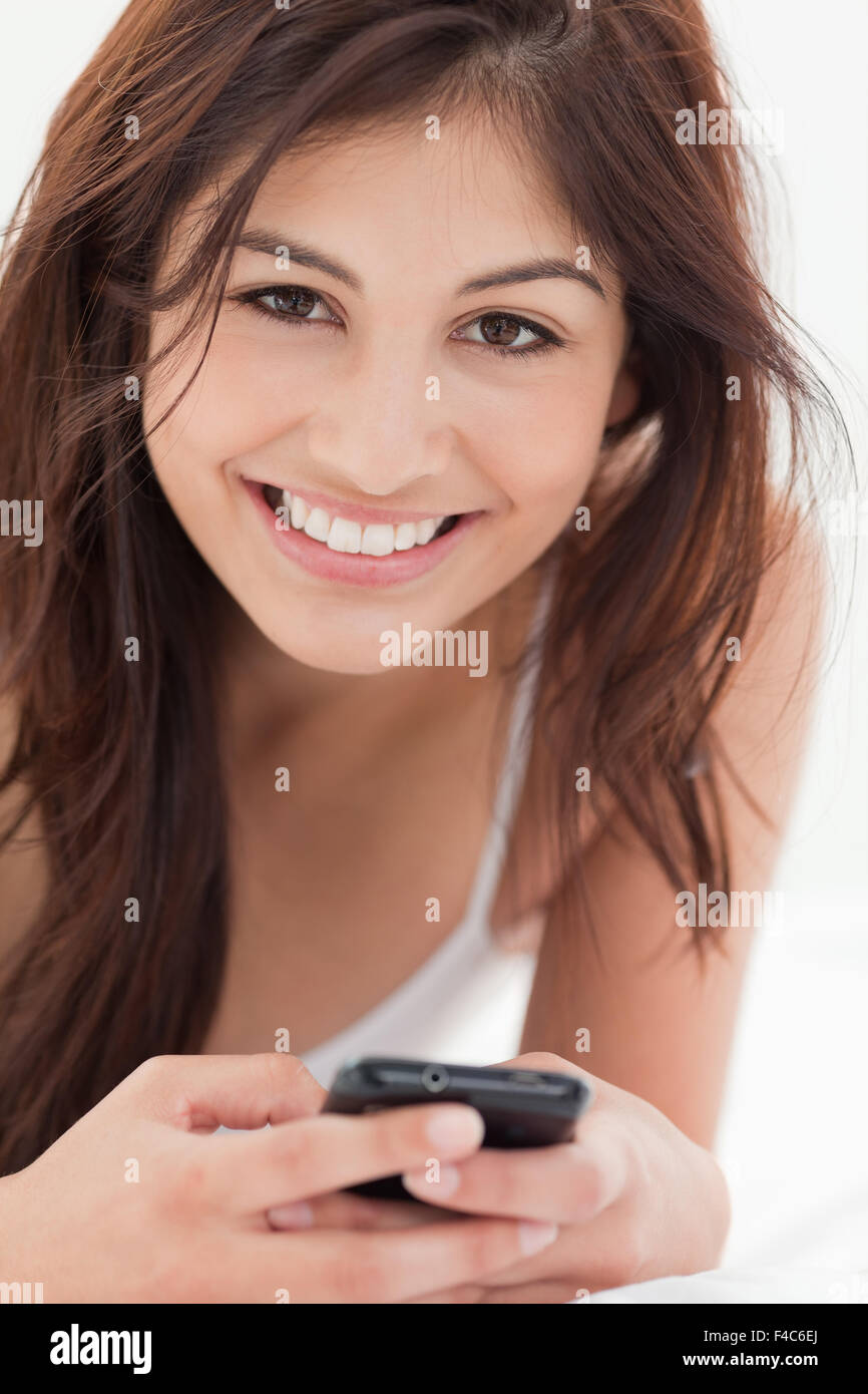 Close up, Smiling woman with her smartphone in hand Stock Photo - Alamy