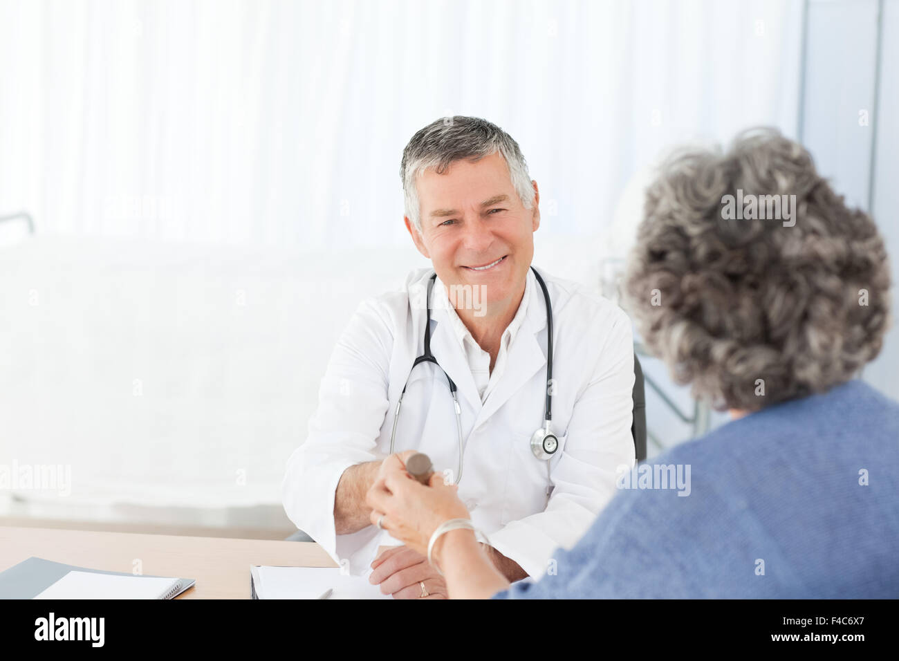 A senior doctor with his patient Stock Photo - Alamy