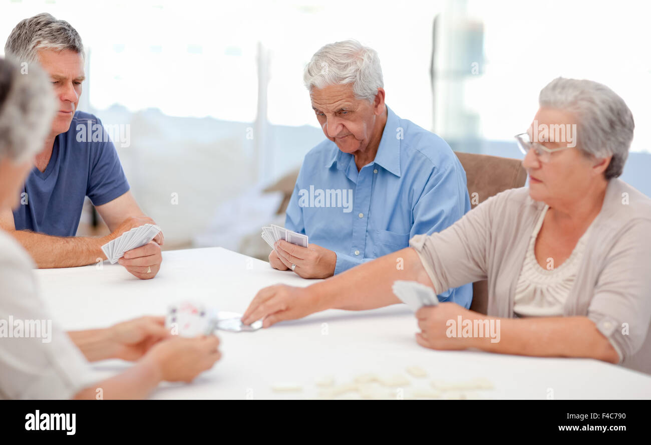 Retired people playing cards together Stock Photo - Alamy
