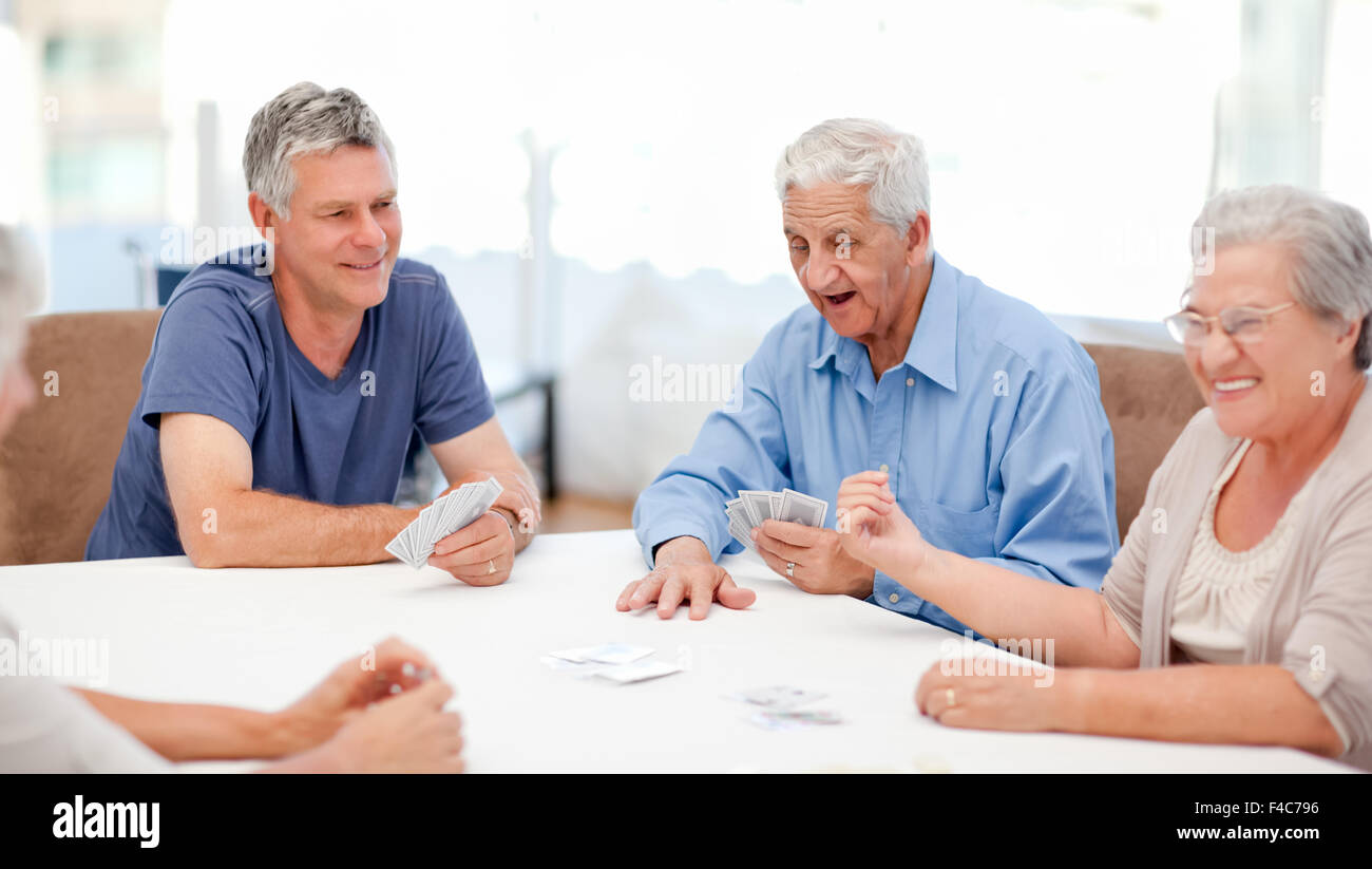 Retired people playing cards together Stock Photo - Alamy