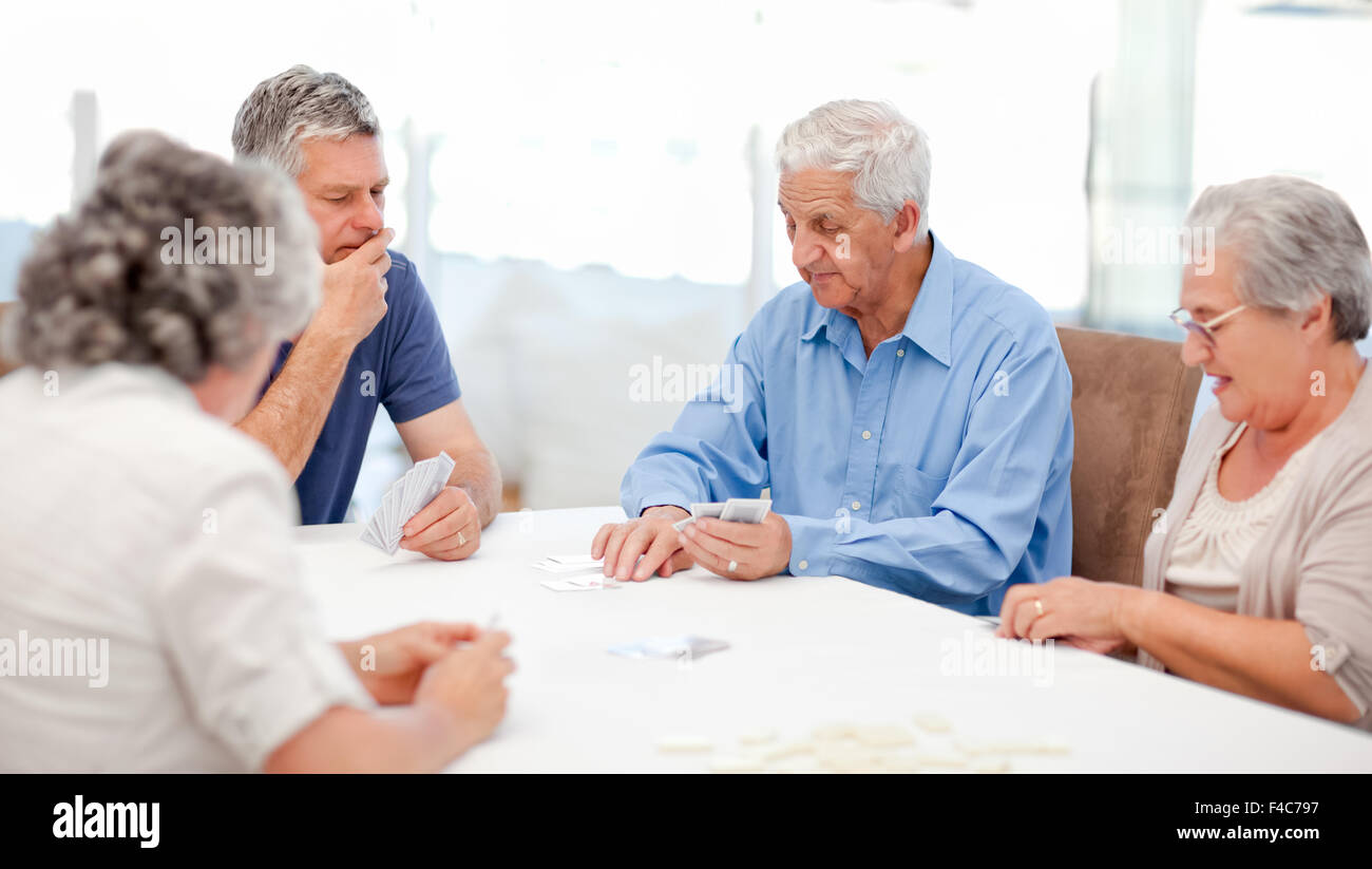 Retired people playing cards together Stock Photo - Alamy