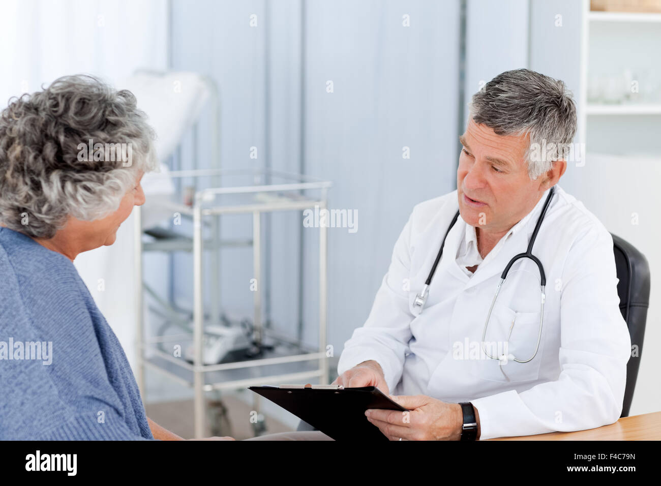 A senior doctor with his patient in his office Stock Photo - Alamy