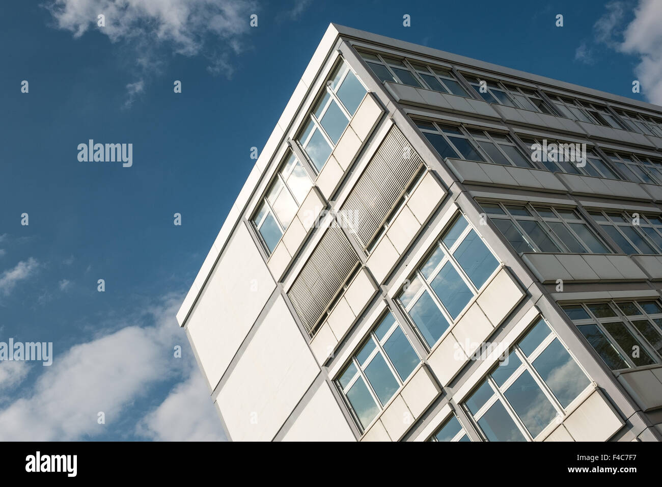 Office building of concrete with windows and shutters Stock Photo - Alamy