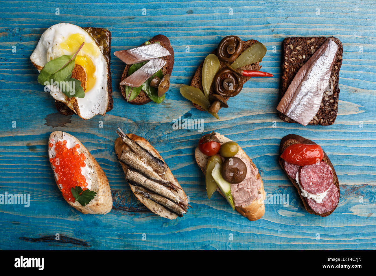Variety of open sandwiches from wholegrain baguette and rye bread with ...