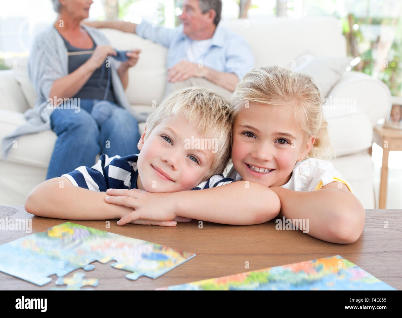 Children looking at the camera in the living room Stock Photo - Alamy