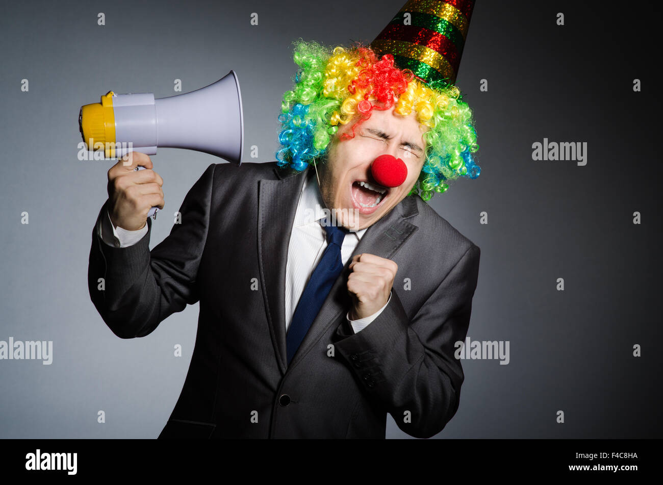 Clown with loudspeaker in funny concept Stock Photo - Alamy