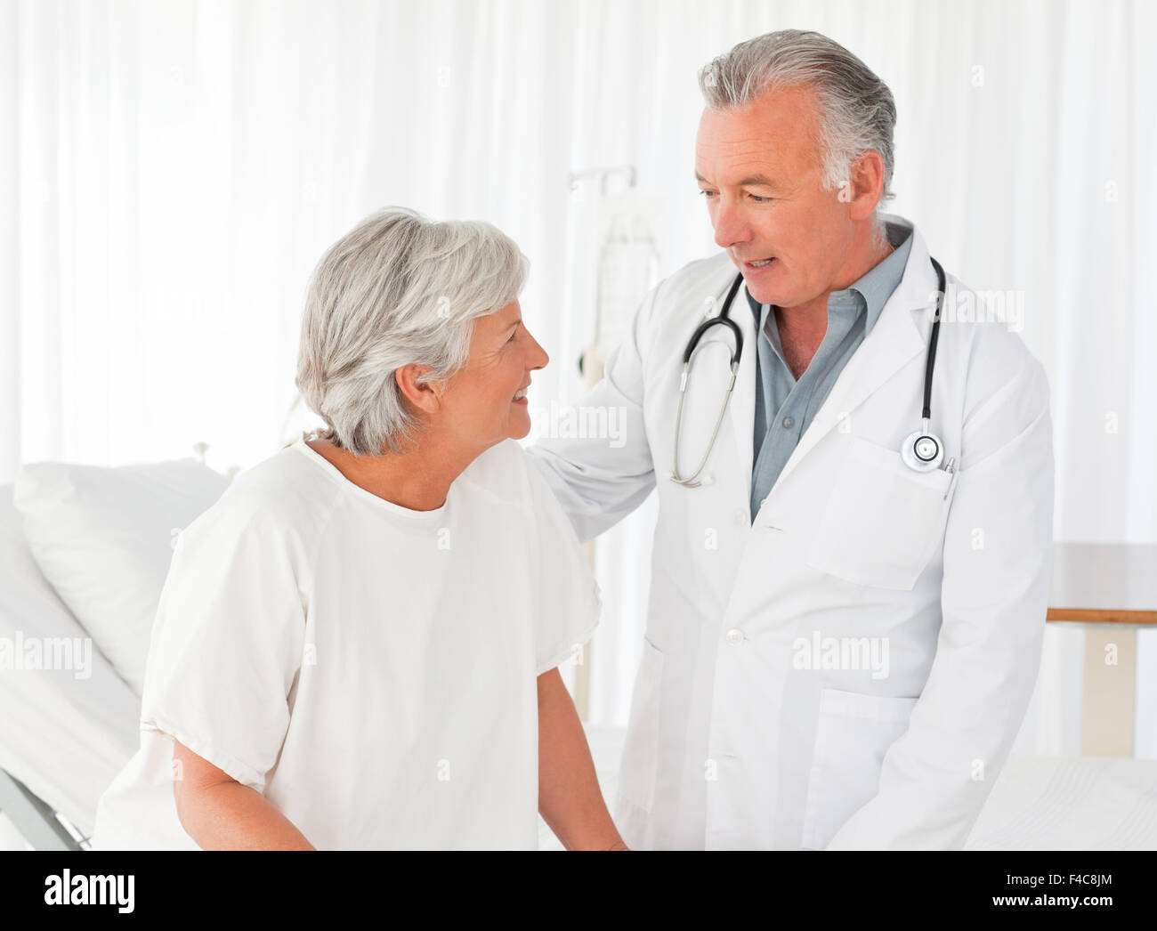 Doctor helping his patient to walk Stock Photo - Alamy