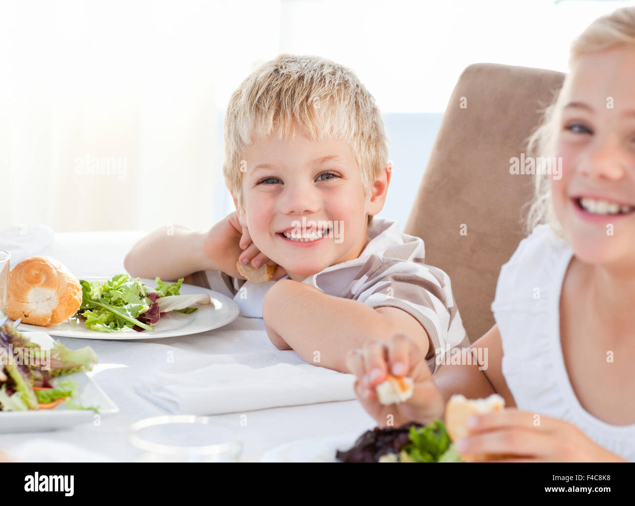 Happy children at the table Stock Photo - Alamy