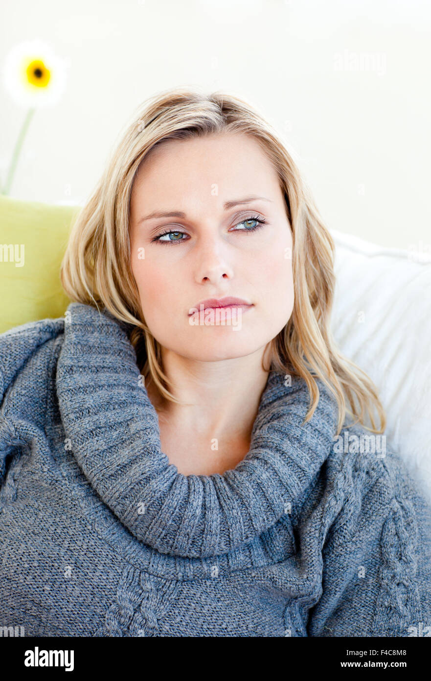 Tired woman lying on the sofa with a grey pullover Stock Photo - Alamy
