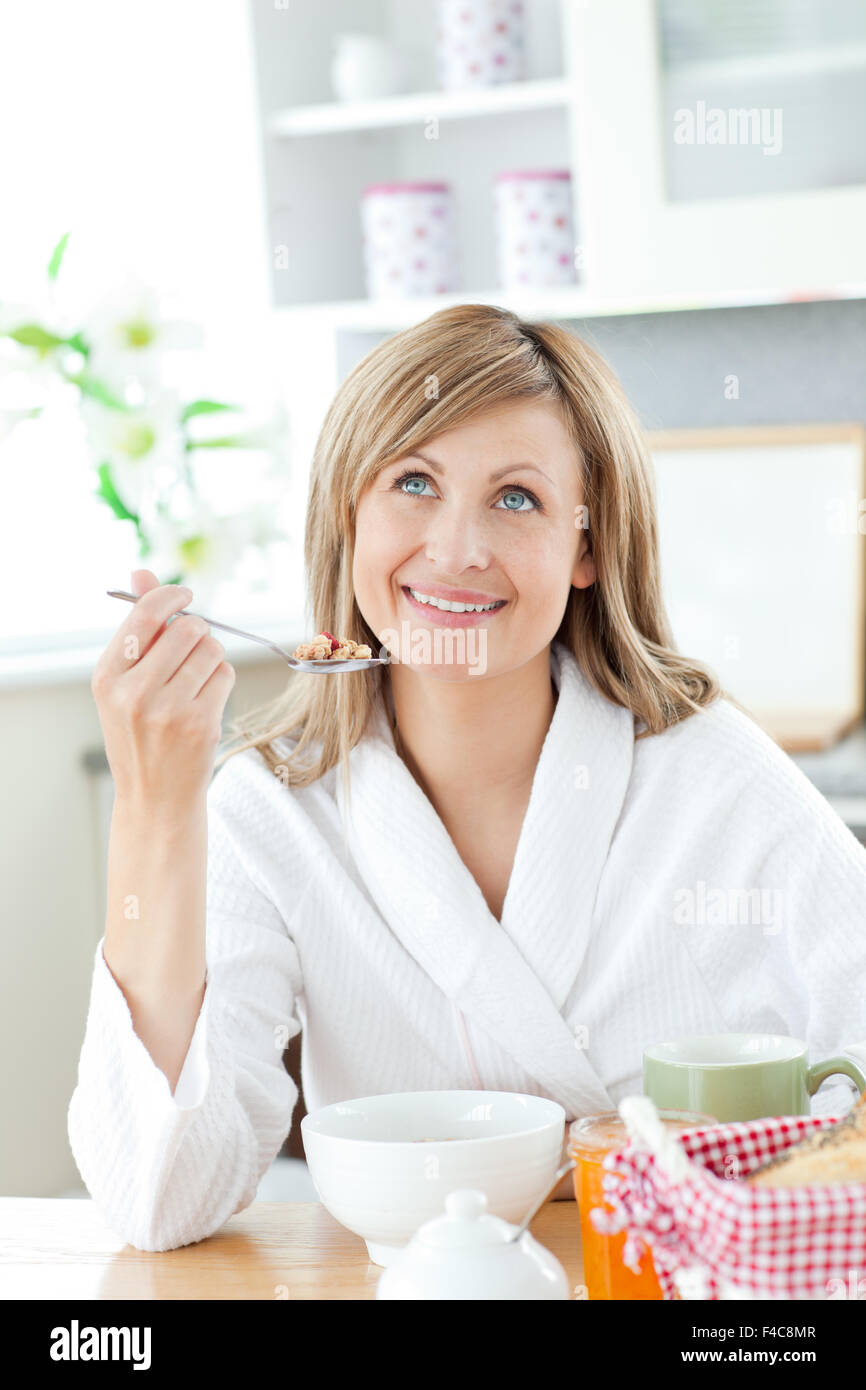 Thinking woman having breakfast in the kitchen Stock Photo - Alamy