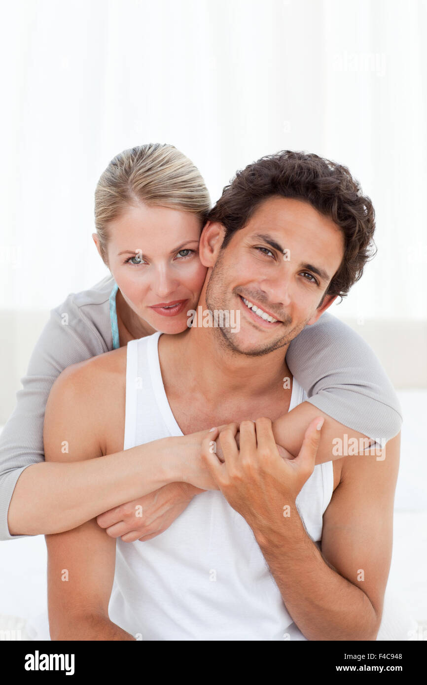 Lovely couple hugging on their bed Stock Photo - Alamy