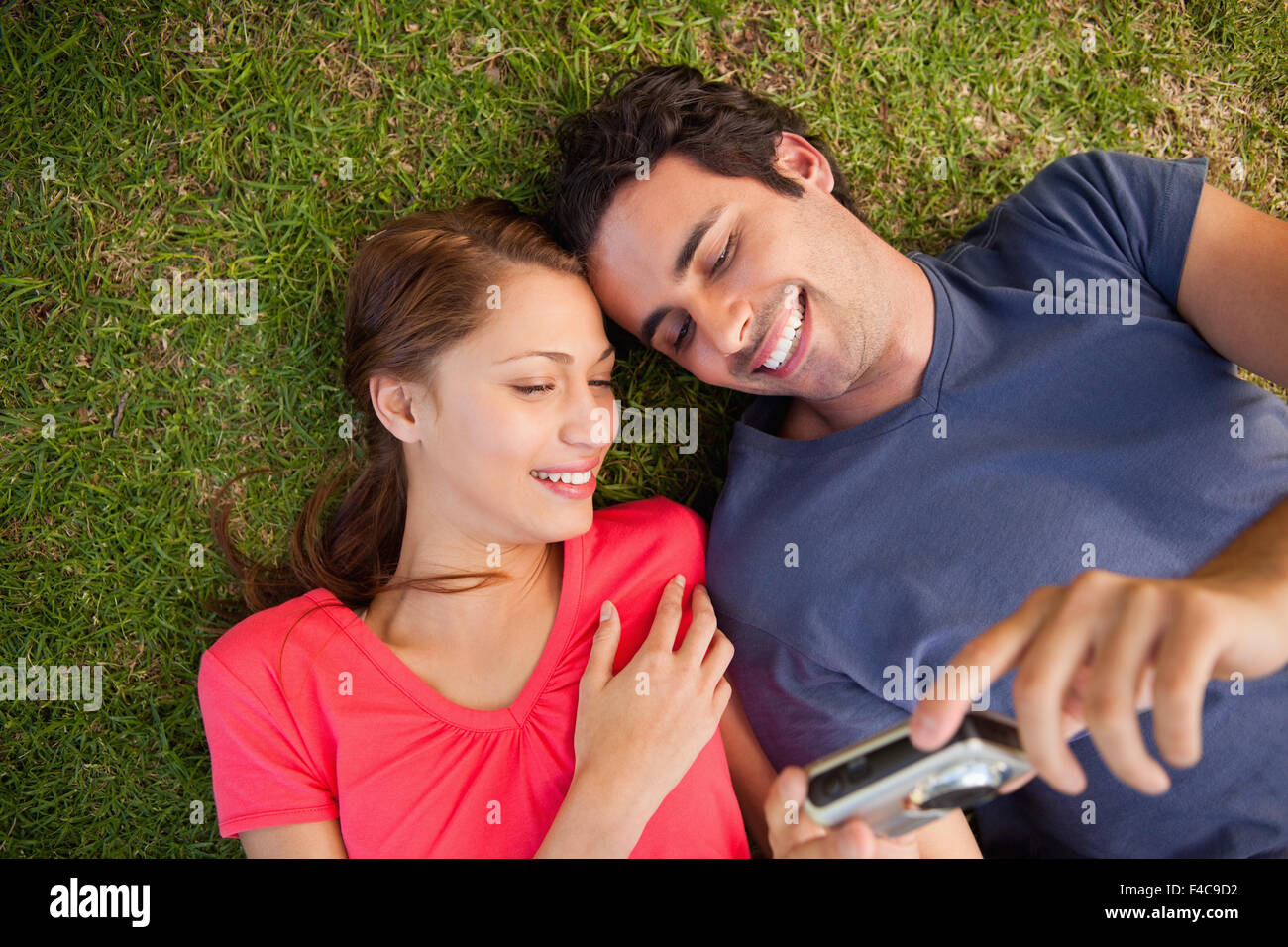 Two smiling friends looking at photos on a camera Stock Photo - Alamy