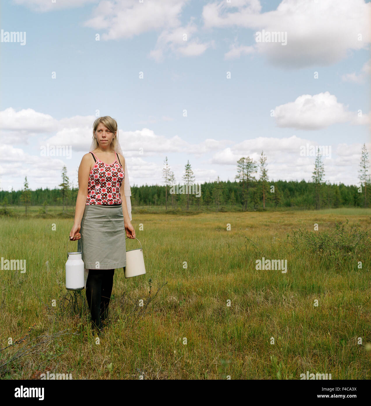 A Woman Carrying Jugs of Milk Stock Photo - Alamy