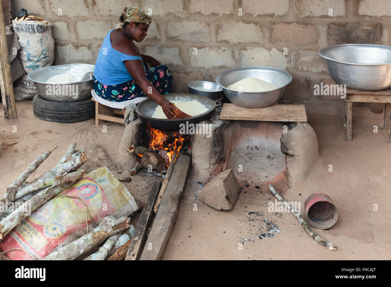 Africa, West Africa, Ghana, Cape Coast, Elmina. Woman cooking in ...