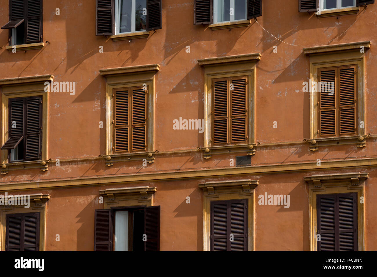 Close up of typical plaster colour and shutters on building in Rome ...