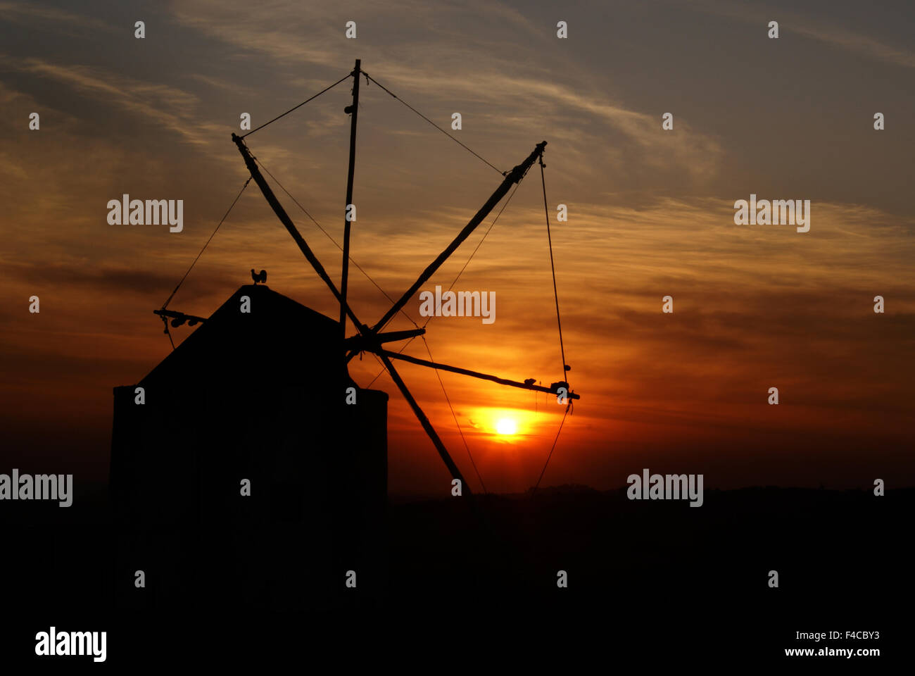 sunset behind old windmill Stock Photo - Alamy