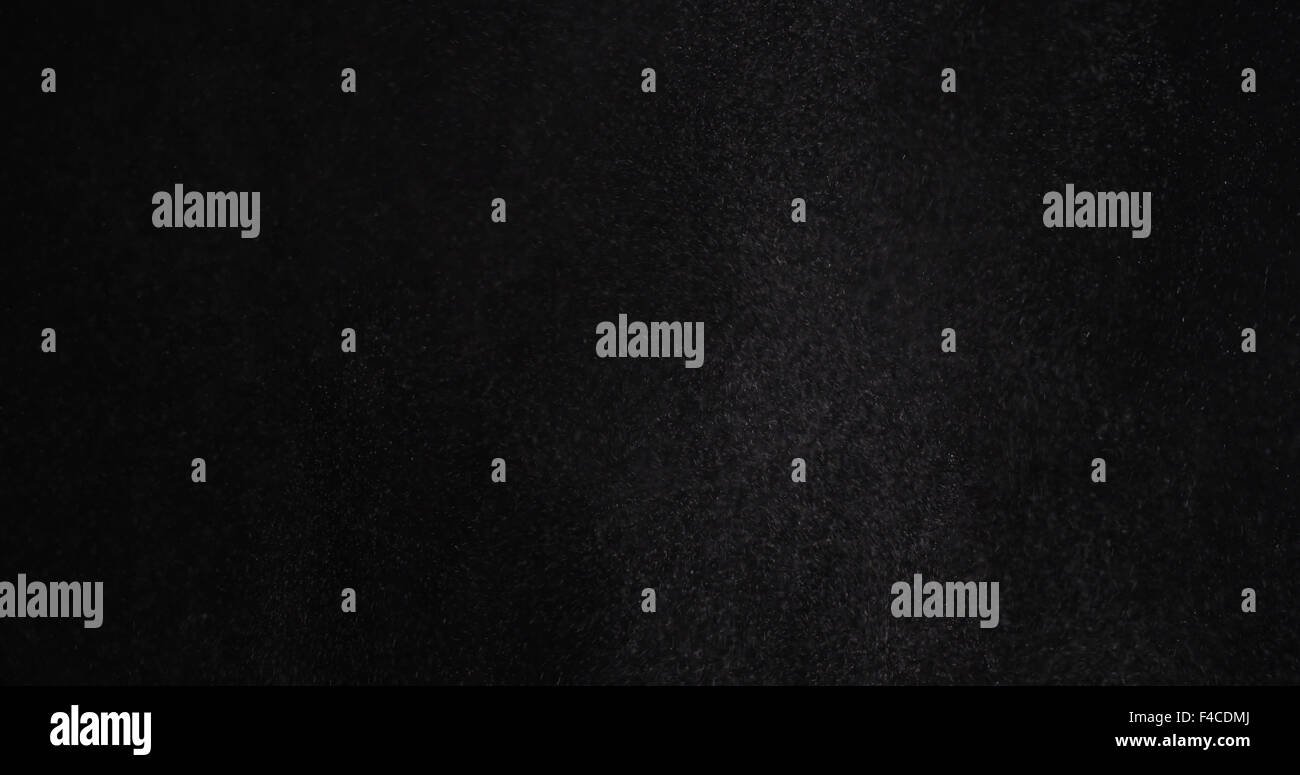 flour dust particles on black background Stock Photo - Alamy