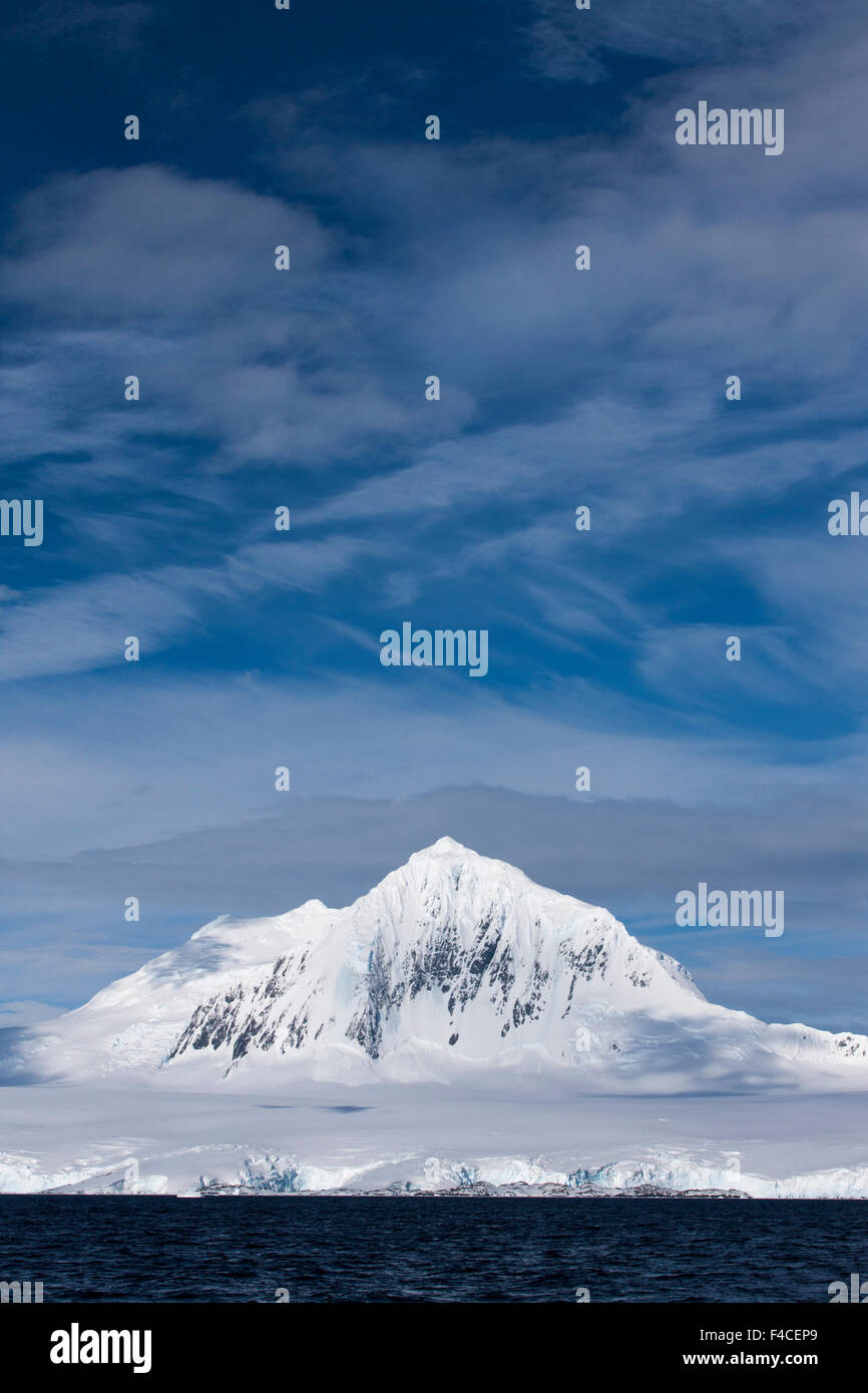 Antarctica, Mountain peak rises above glacier along Bismarck Strait ...