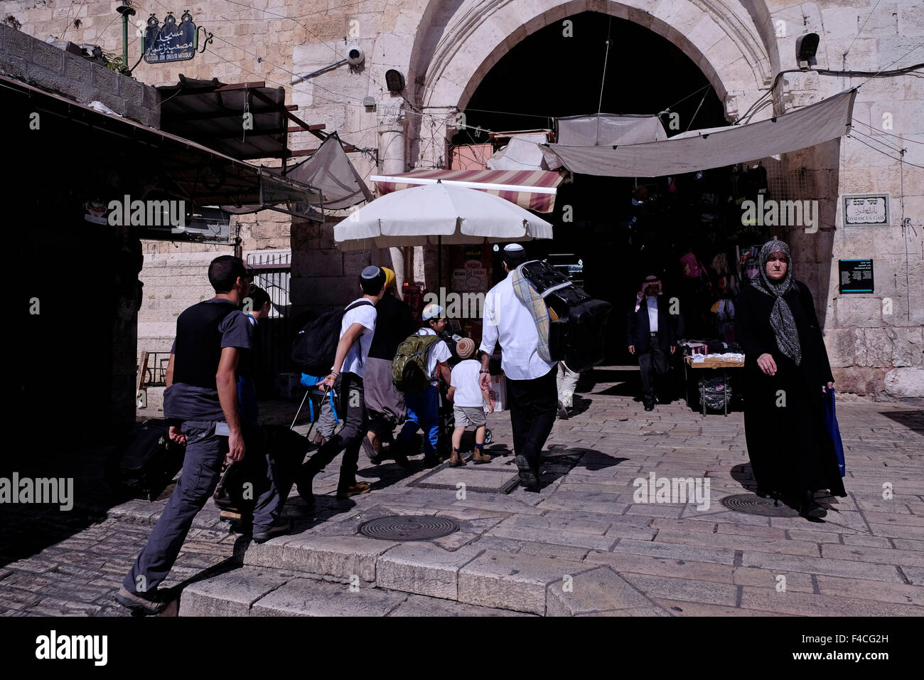 A religious Jewish family being escorted by security guards walk ...