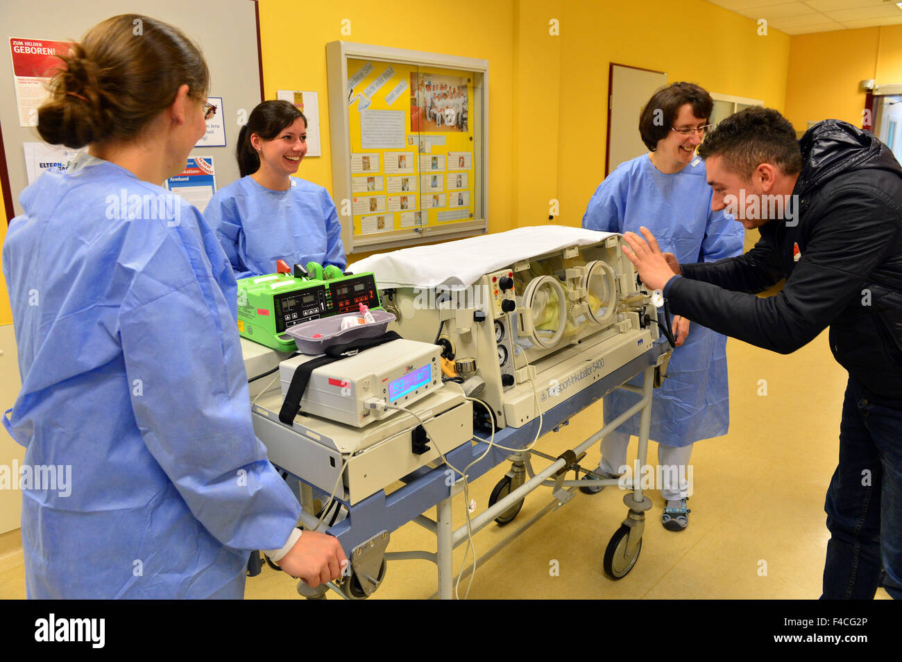 Jena, Germany. 16th Oct, 2015. Nurses care for one of the four newborns ...