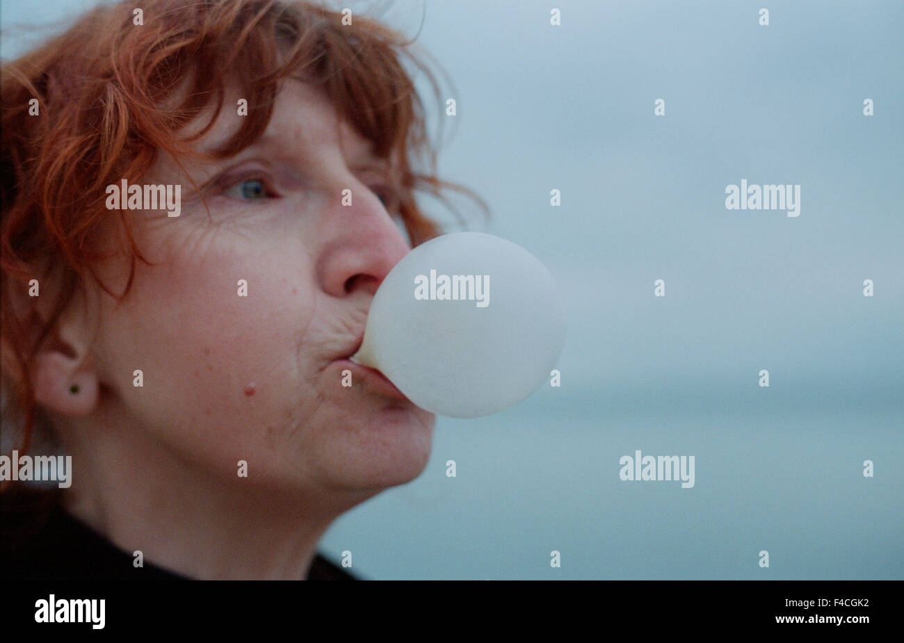 A middle aged woman with chewing gum Stock Photo - Alamy