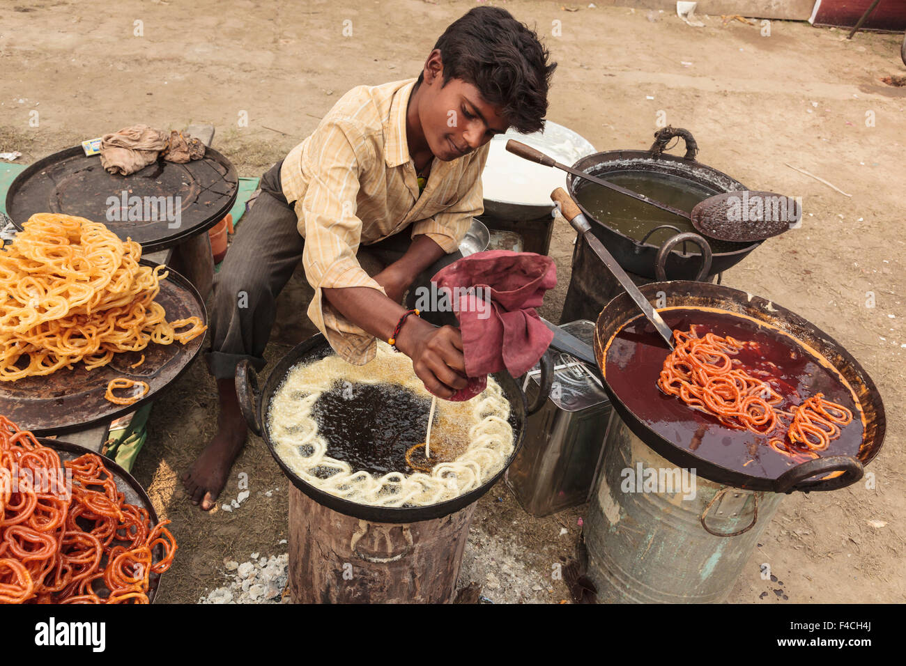 India, Odisha, Subarnapur District, Sonepur, Man preparing street food ...