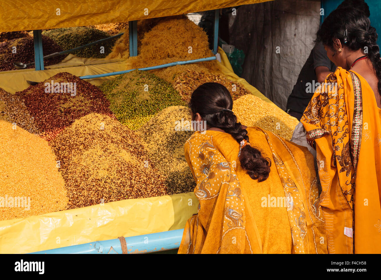 India, Odisha, Subarnapur District, Subarnapur, Women buying farsan ...