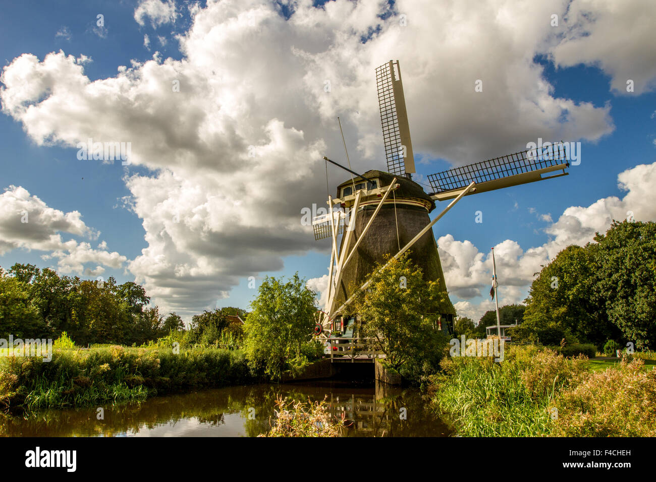 Traditional Dutch windmill on canal Stock Photo - Alamy