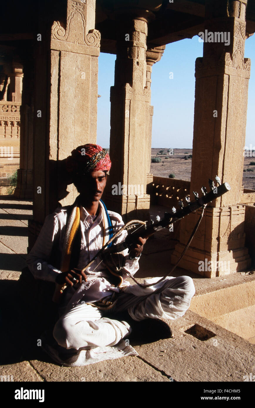 India, Rajasthan, Jaisalmer, Musician in Amar sagar palace playing ...