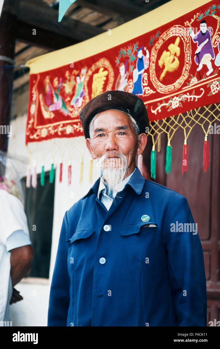 China, Yunnan Province, Baoshan, Old man standing in funeral ceremony ...