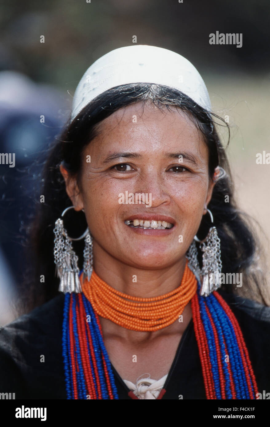 China, Yunnan Province, Simao District, Woman wearing sliver headband ...