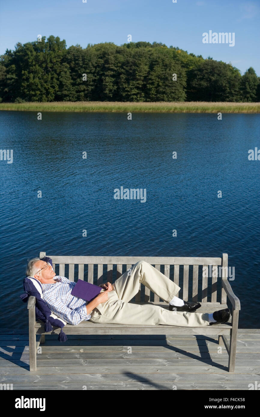 A man sleeping on a bench Stock Photo - Alamy