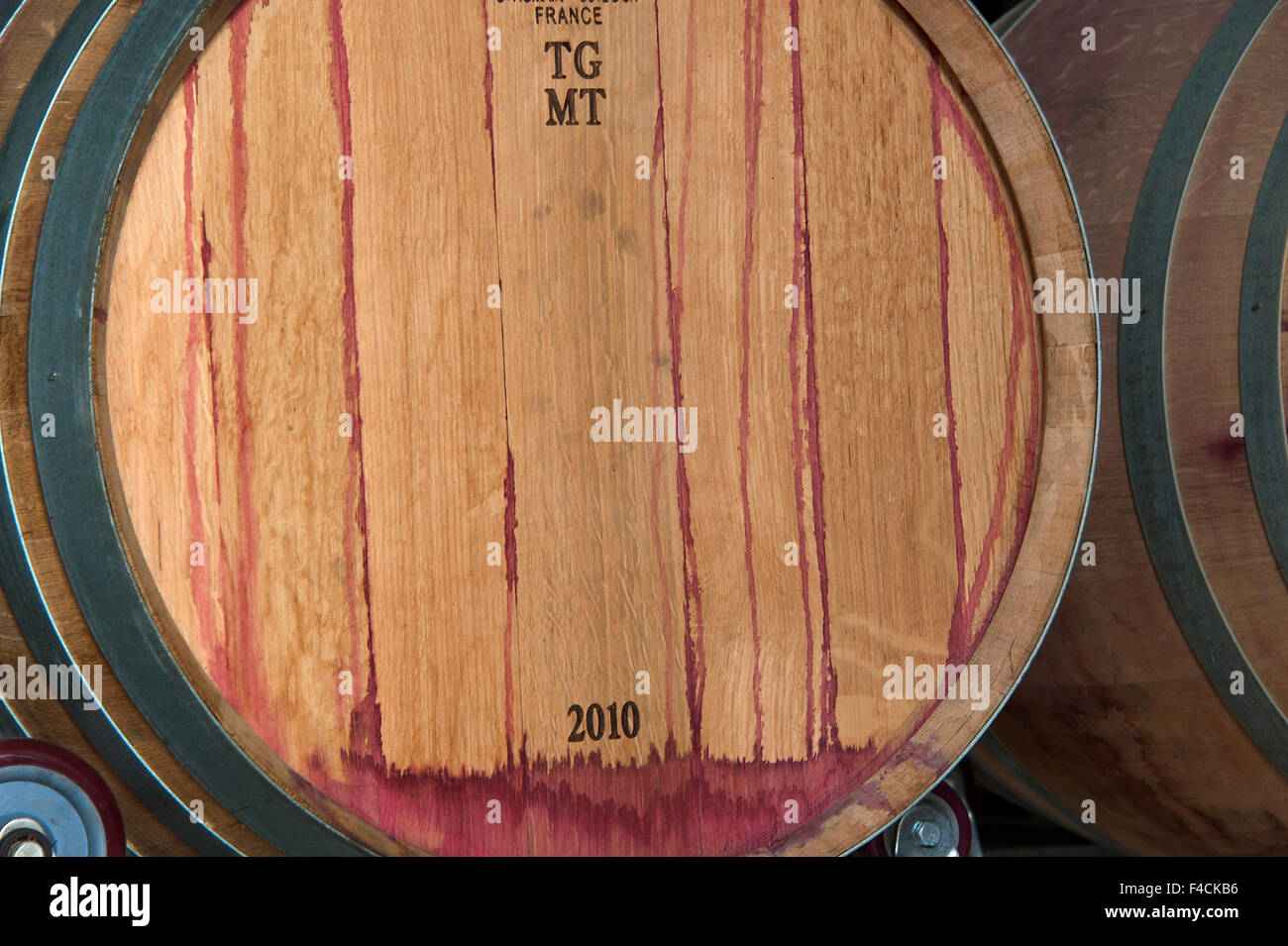 China, Ningxia. Red wine stains the end of an oak barrel at Helan ...