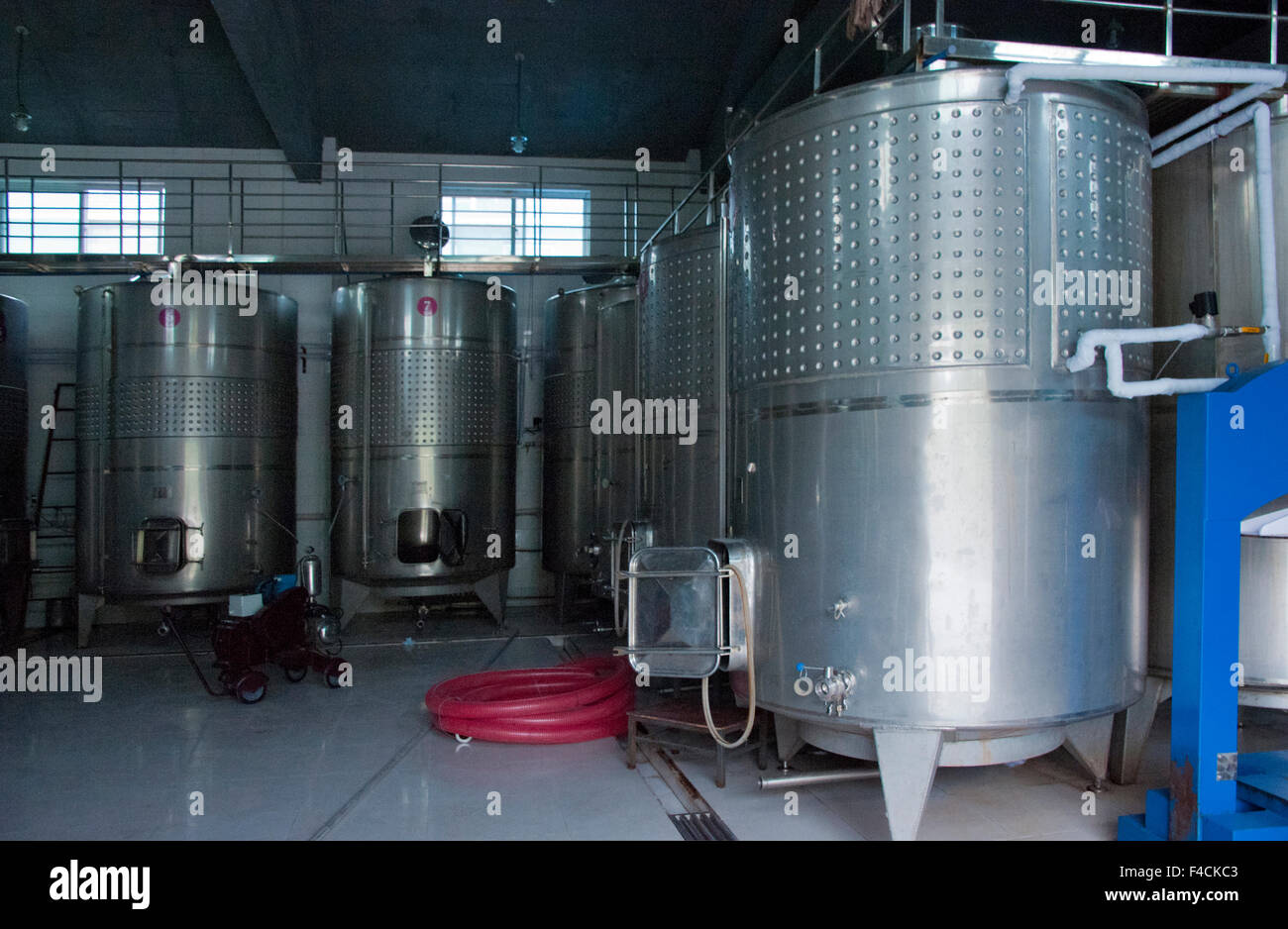 China, Ningxia, Yinchuan. Empty stainless steel fermenting tanks sit at ...