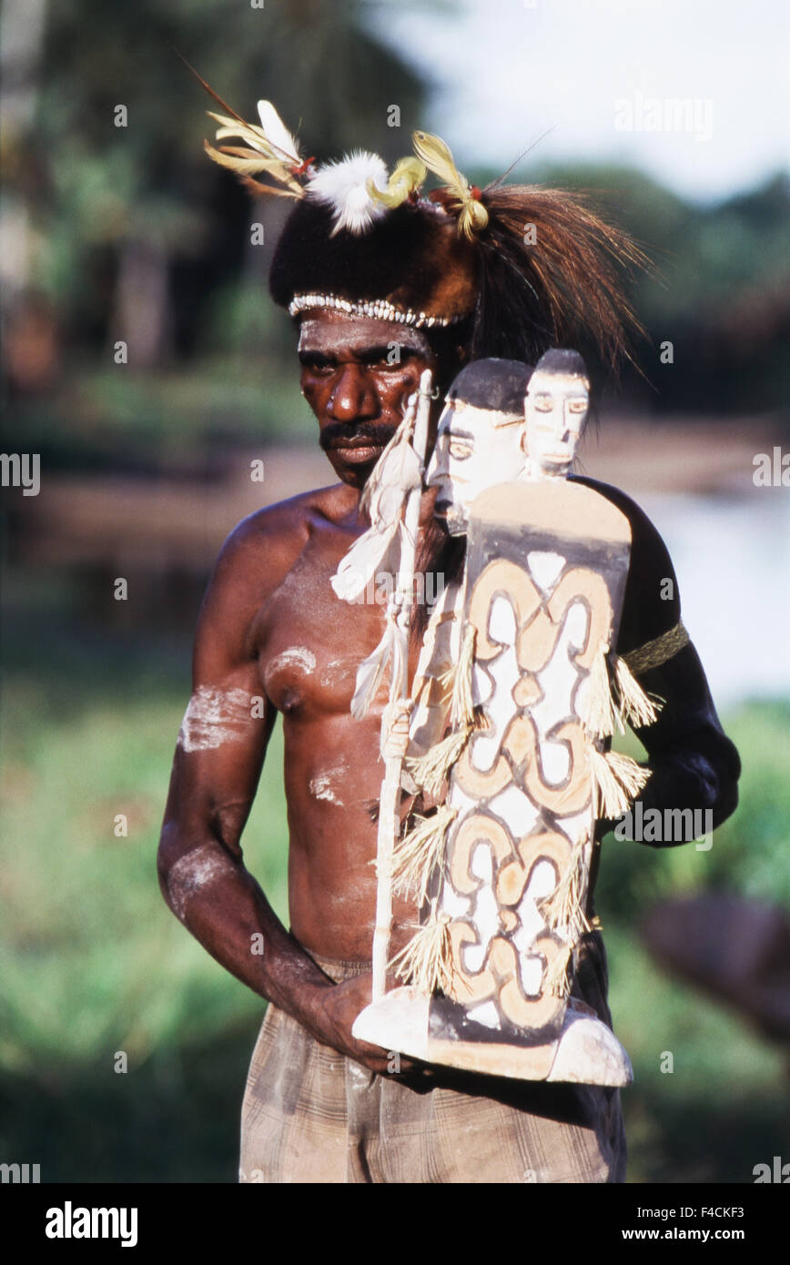 Indonesia, Irian Jaya, Asmat man holding statue. (Large format sizes ...