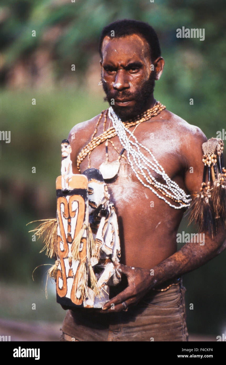 Indonesia, Irian Jaya, Asmat man holding statue. (Large format sizes ...