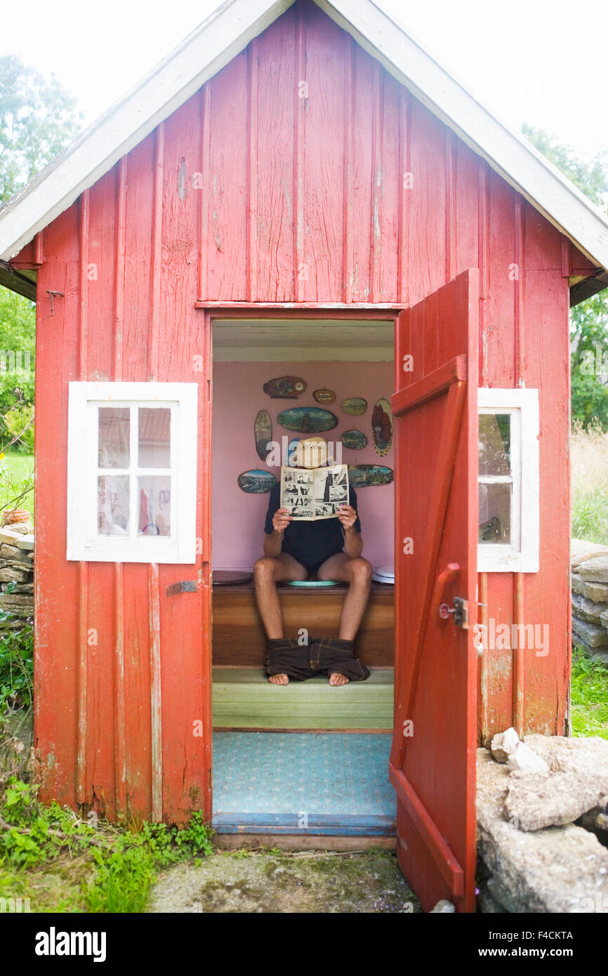 A man in an outhouse Stock Photo - Alamy