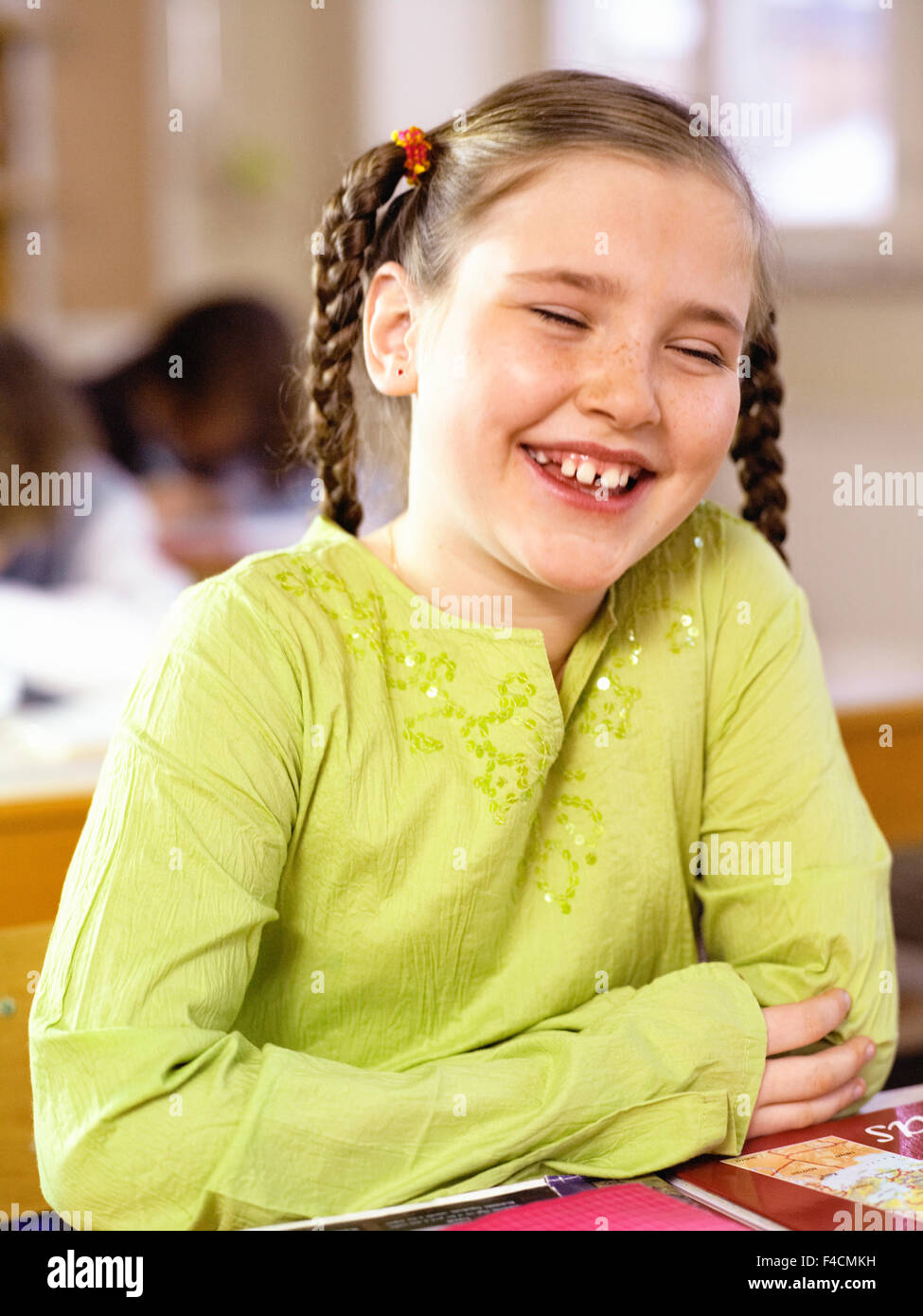 Happy girl in classroom Stock Photo - Alamy