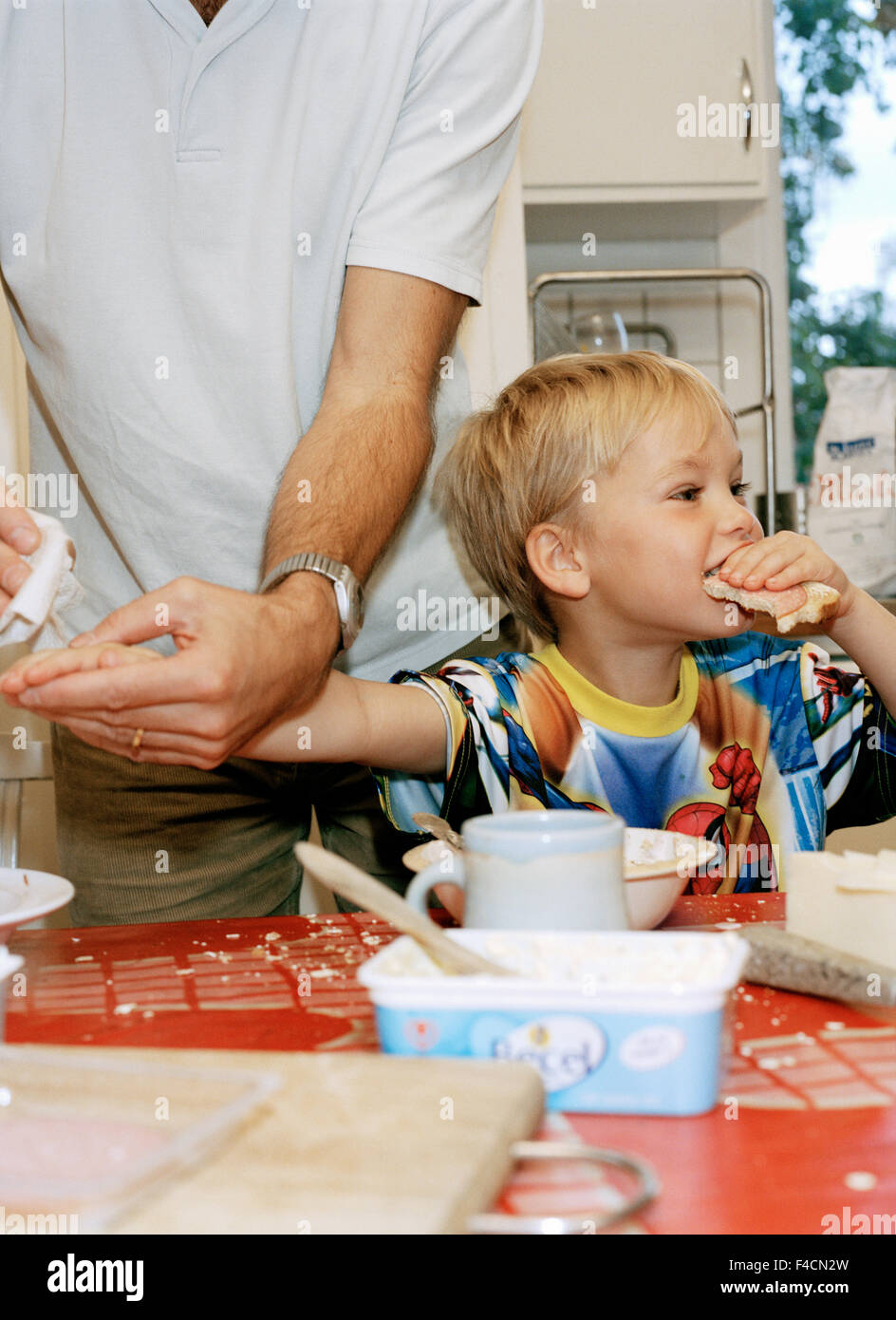 A boy by a breakfast table Stock Photo - Alamy