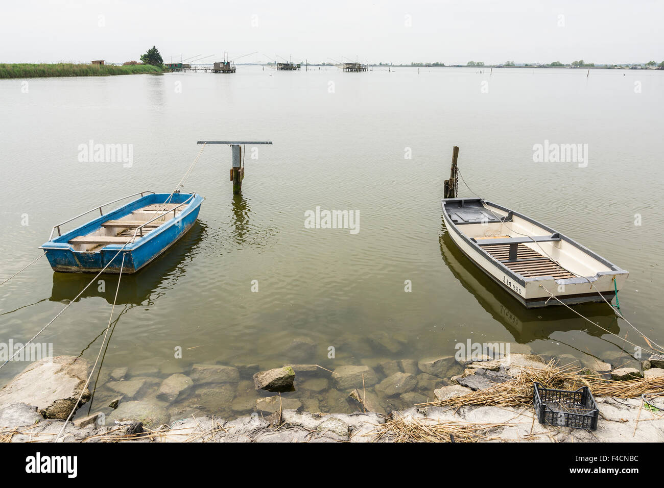 Old fishing boats moored in a swamp during a cloudy day Stock Photo - Alamy