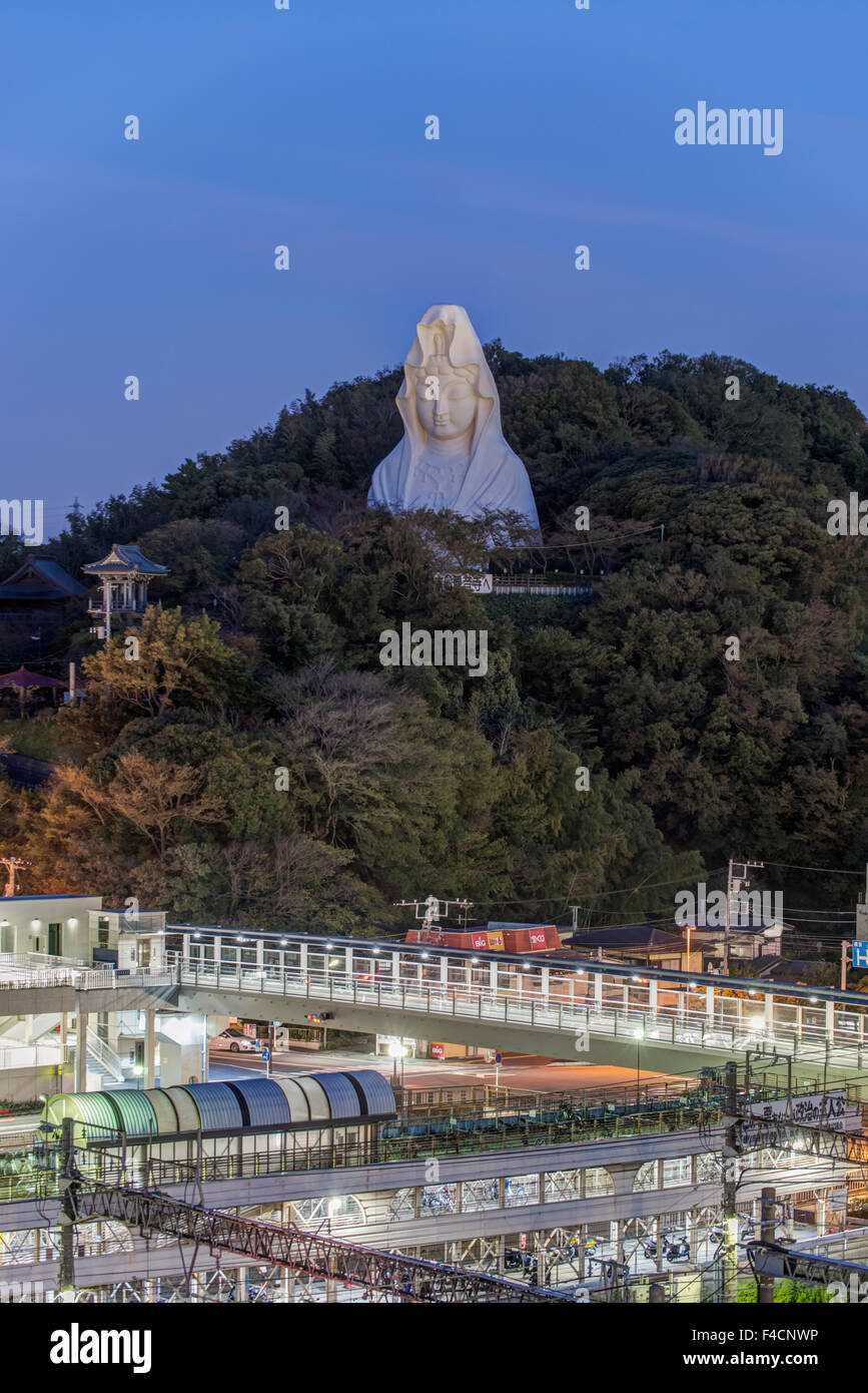 Japan, Kanagawa, Kamakura, Ofuna Kannon and Ofuna Station at dawn ...